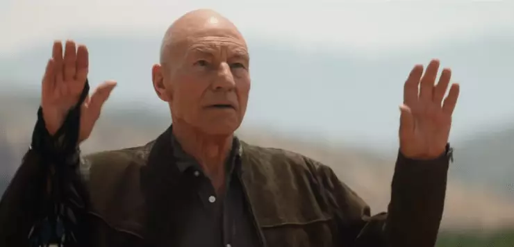 Jean-Luc Picard (Patrick Stewart) kalayan panangan diangkat pasrah dina Star Trek: Picard